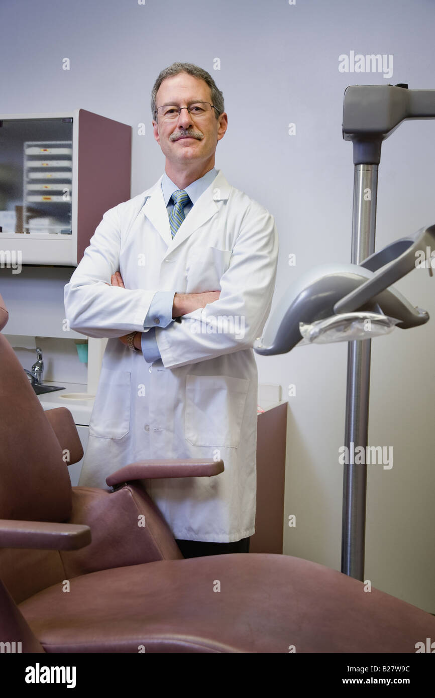 Male dentist with arms crossed Stock Photo - Alamy