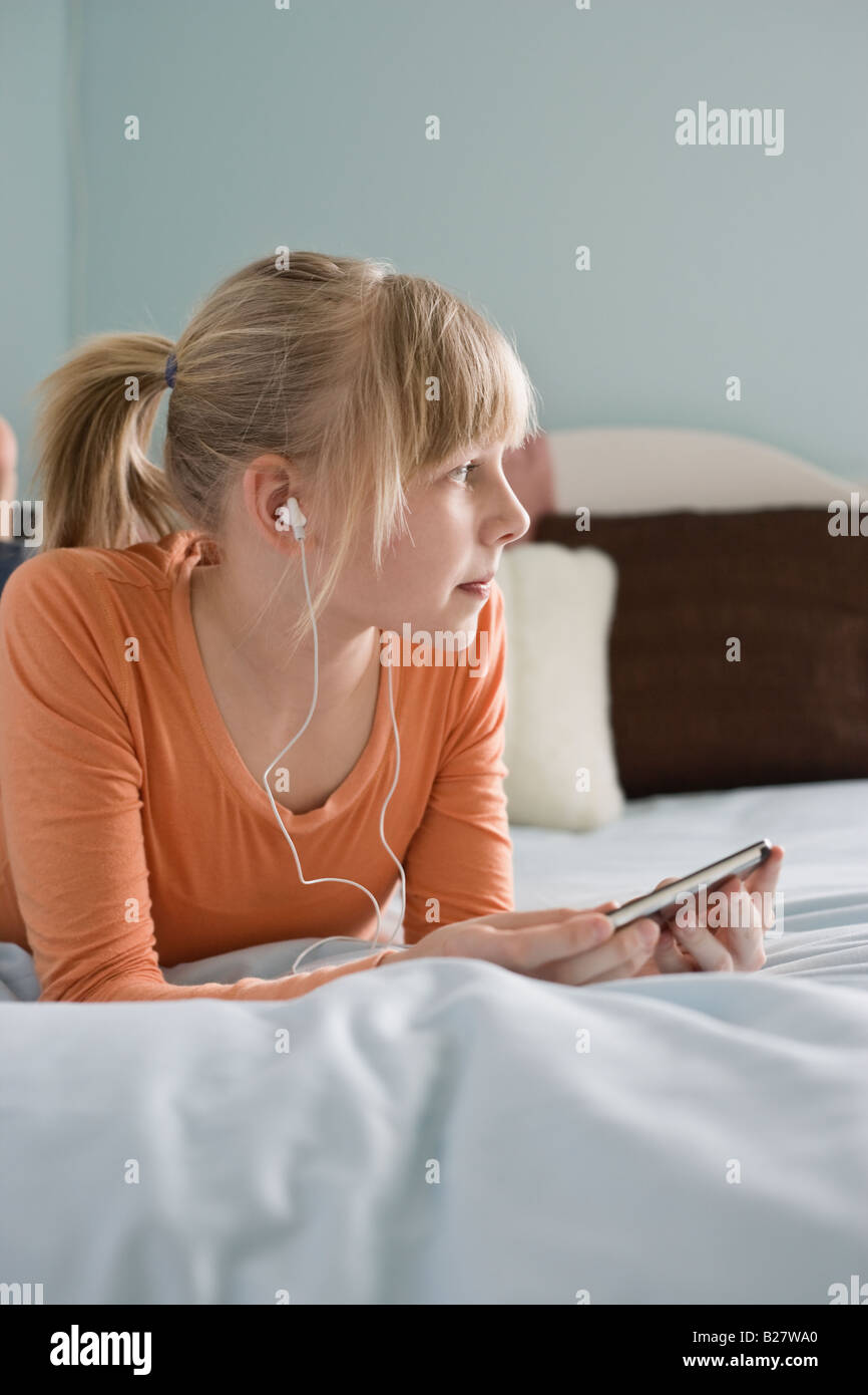 Girl listening to mp3 player Stock Photo - Alamy