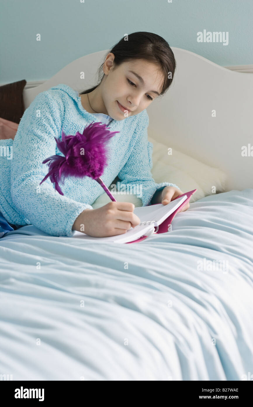 Girl writing in diary Stock Photo - Alamy