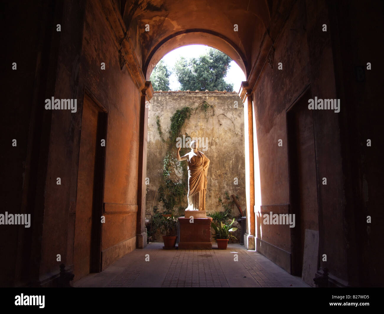 one roman female statue in a courtyard in a villa in rome italy Stock ...