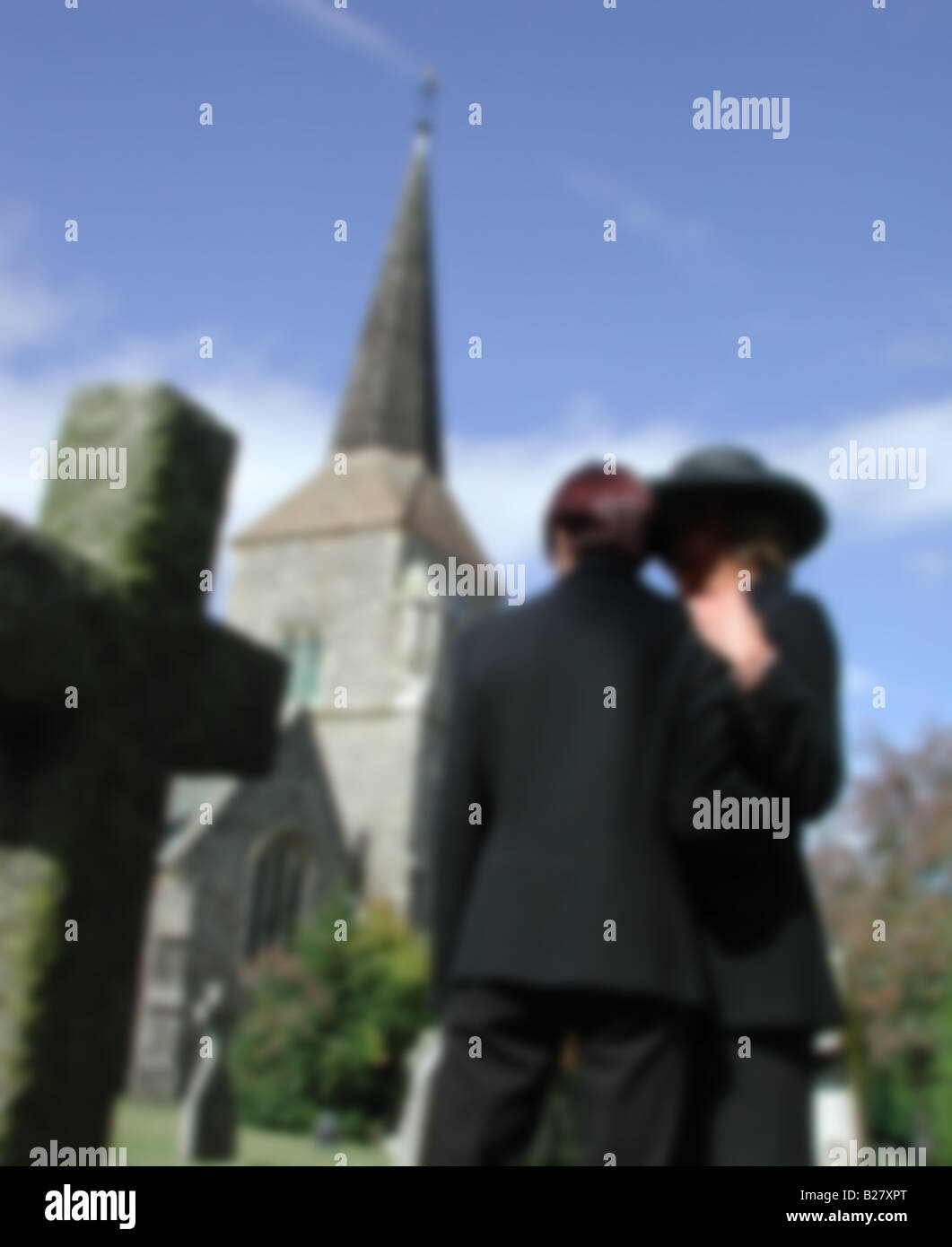 Two women comfort each other at a grave Stock Photo - Alamy