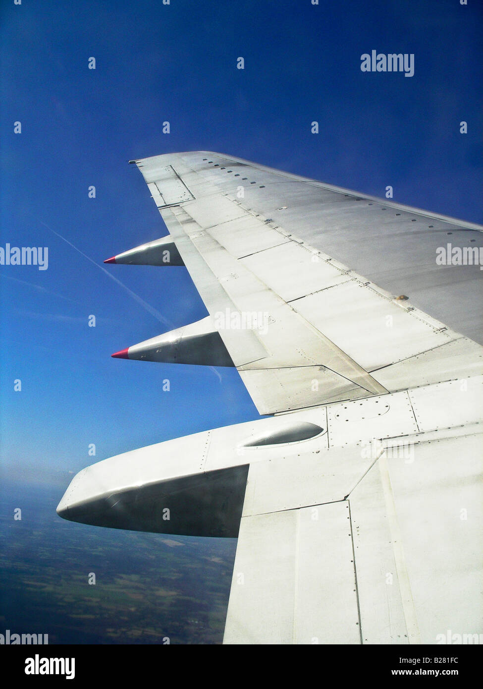 Aircraft port wing mainplane in flight at altitude Seen through ...
