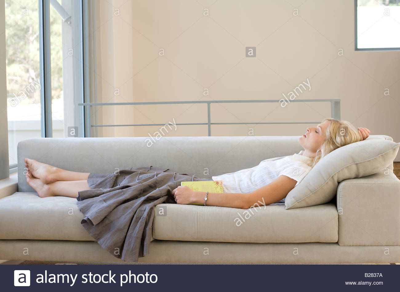 Young Woman Sleeping On Sofa Stock Photos & Young Woman Sleeping On ...