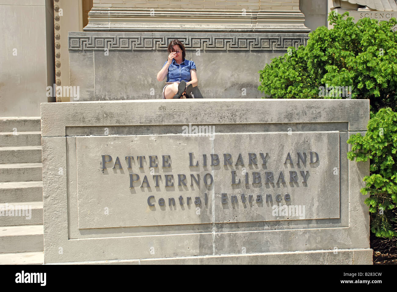 Female student sitting outside the Pattee and Paterno Library of Penn ...