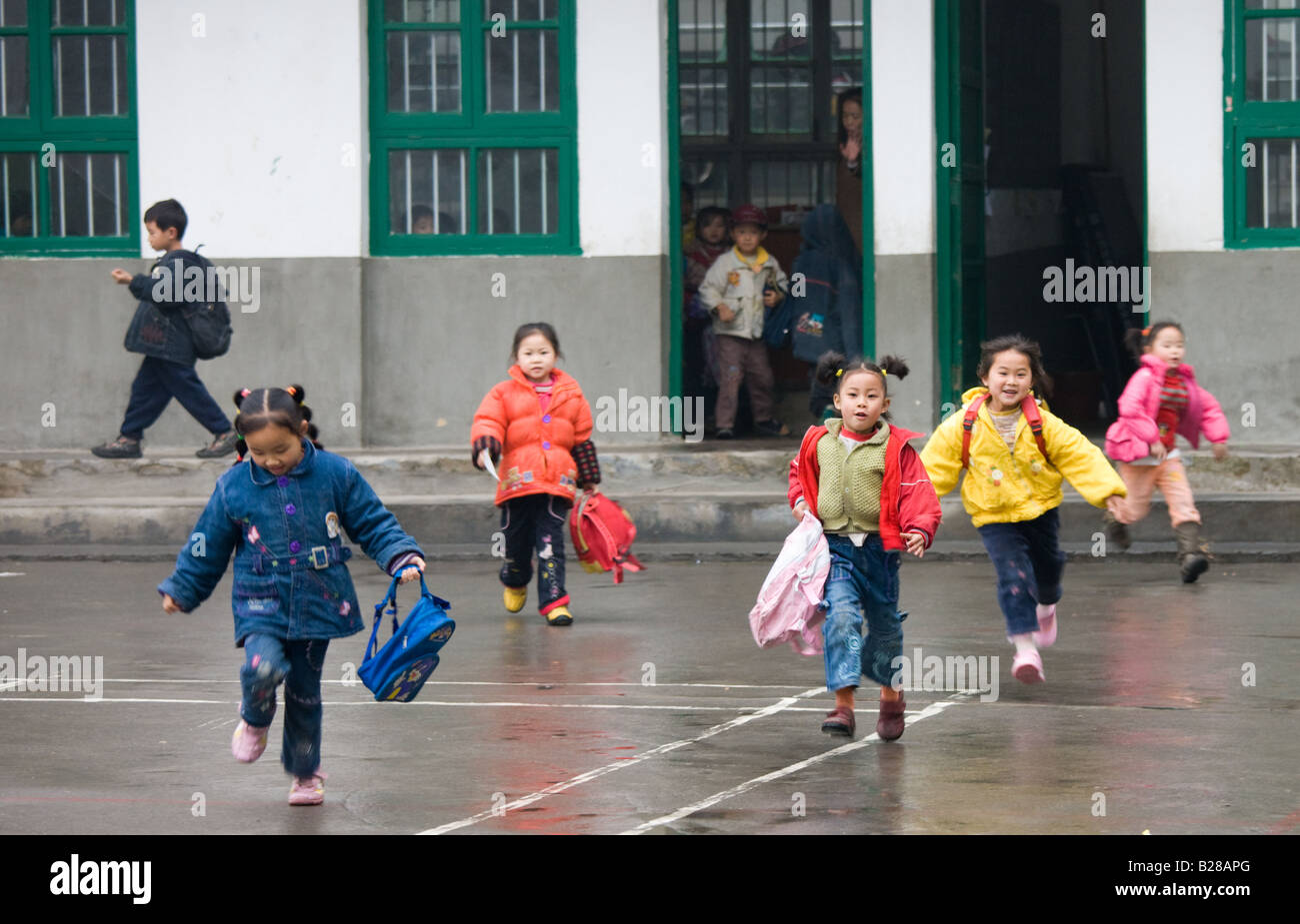 Children run through the playground of a primary school in Fuli China ...