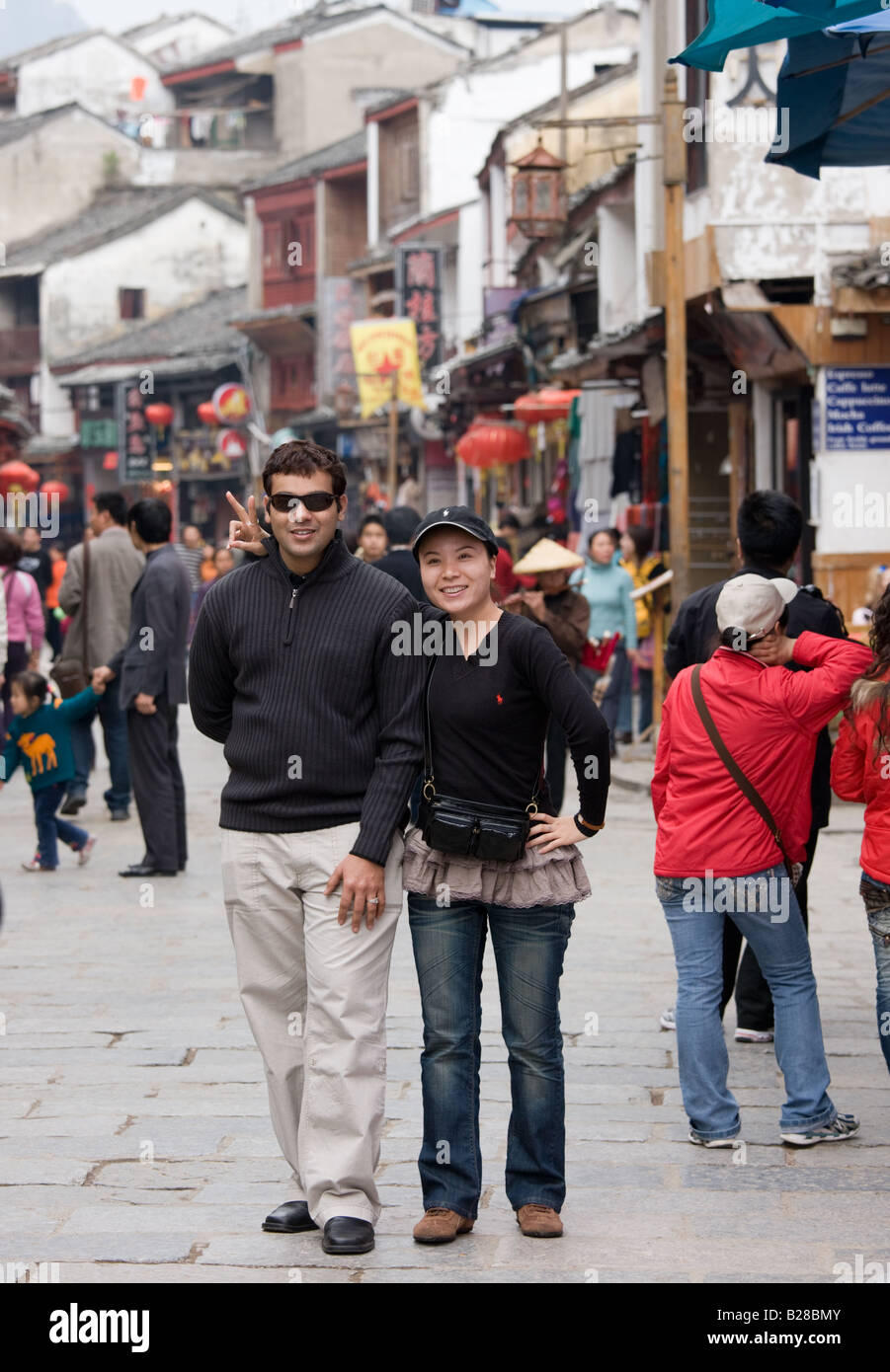 Couple walk down shopping street in Yangshuo China Stock Photo - Alamy