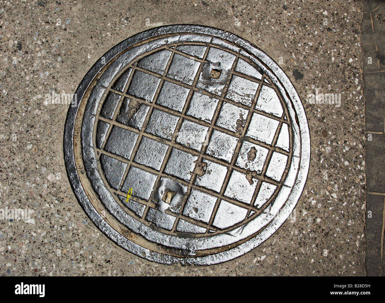 small manhole cover on a greek island Stock Photo - Alamy