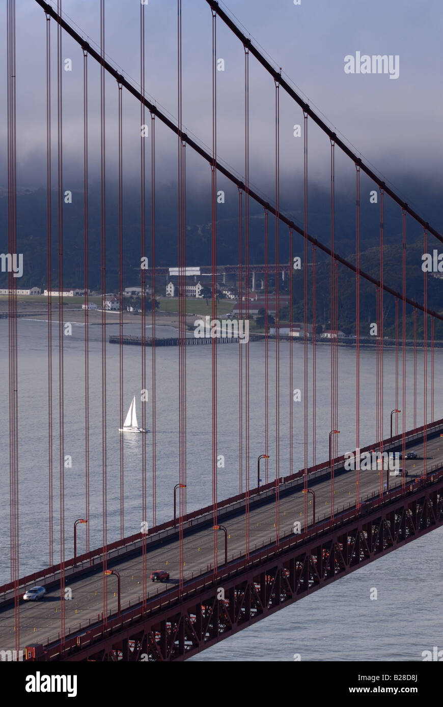 Boat in the bay behind Golden Gate Bridge on an overcast day Stock ...
