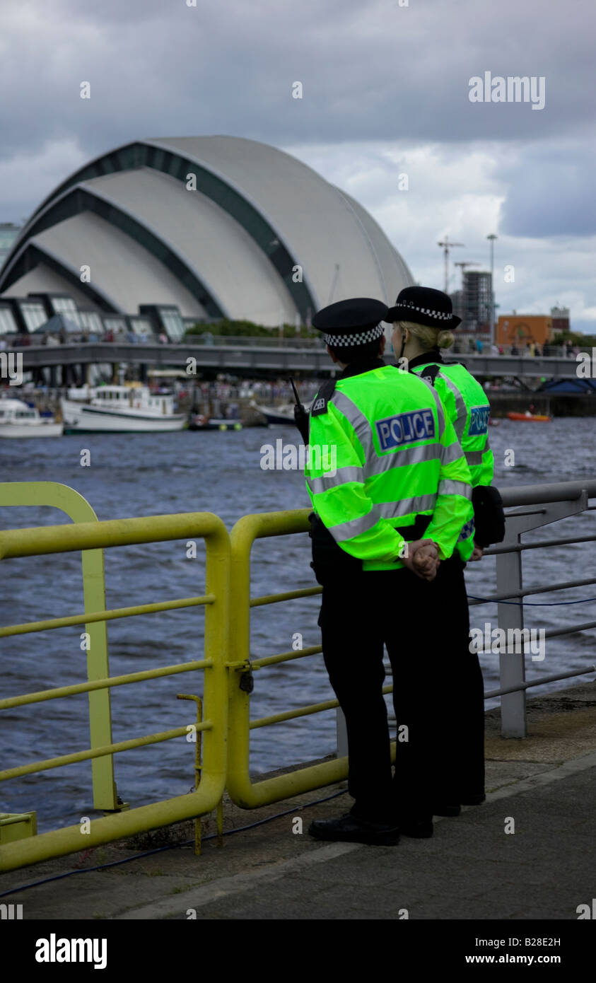 Male and female police officers, by the River Clyde, Glasgow, Scotland ...