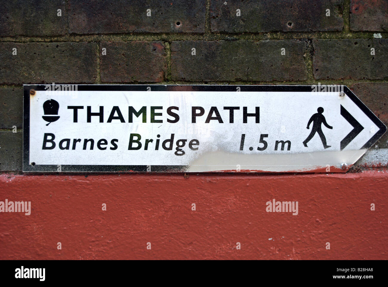 black and white street sign for the thames path near hammersmith bridge ...