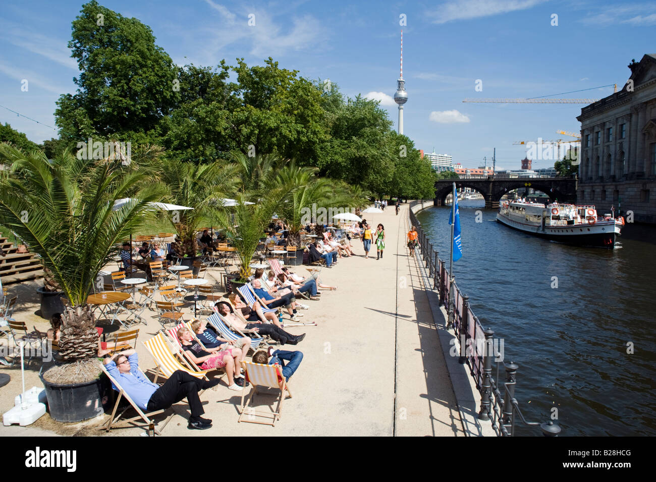 Summer riverside cafe beside Spree River in central Berlin Germany 2008 ...