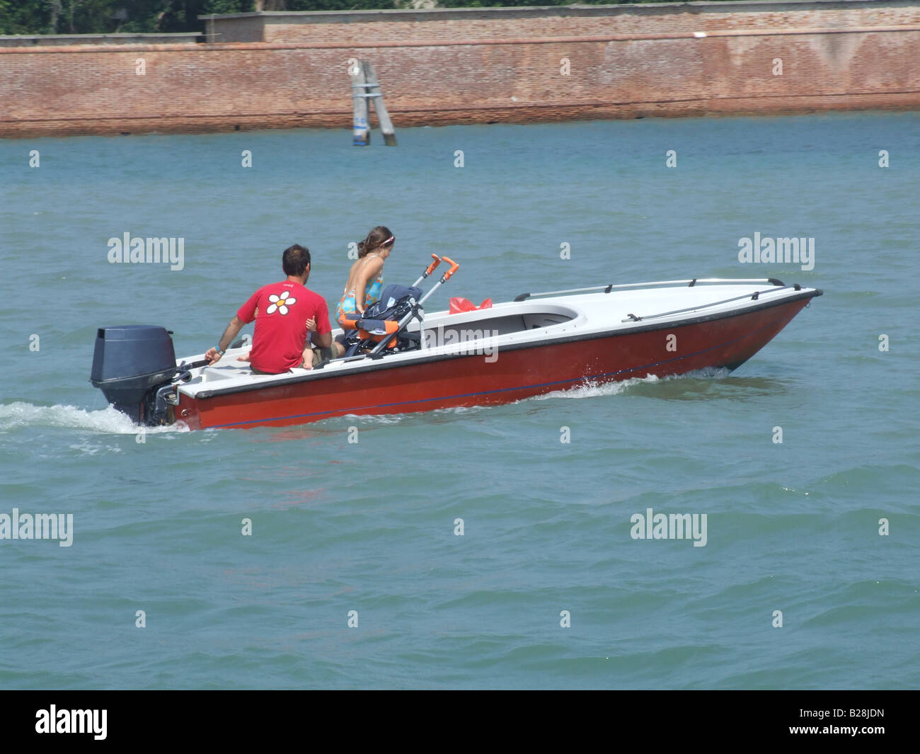 fast boat with young family on canal in venice, italy Stock Photo - Alamy