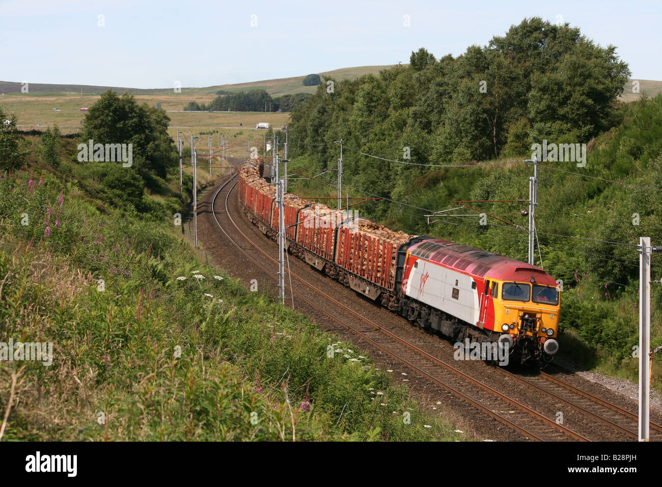 Class 57 diesel locomotive with a loaded freight train (timber ...