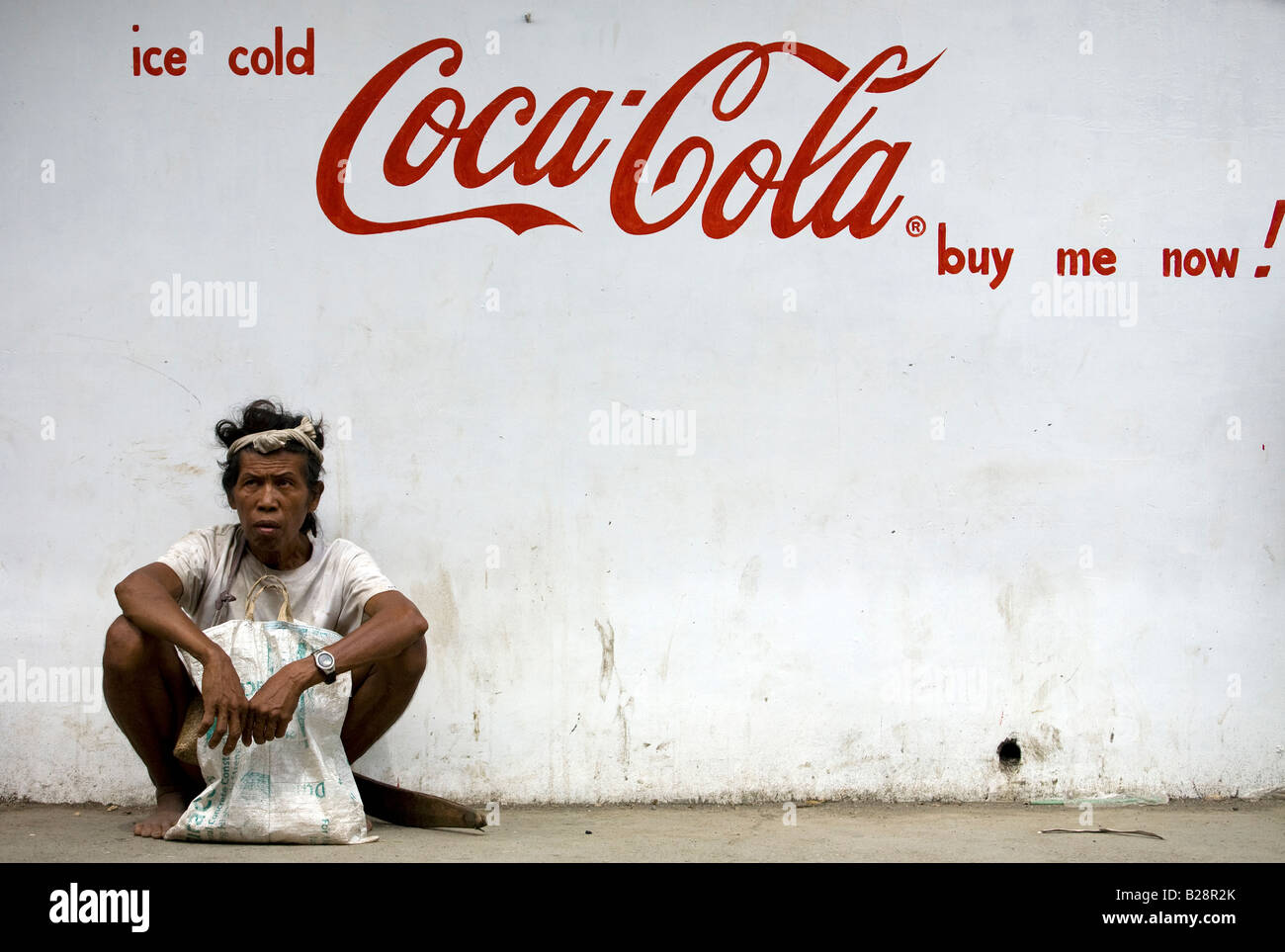 A Mangyan man waits for members of his family while visiting the ...