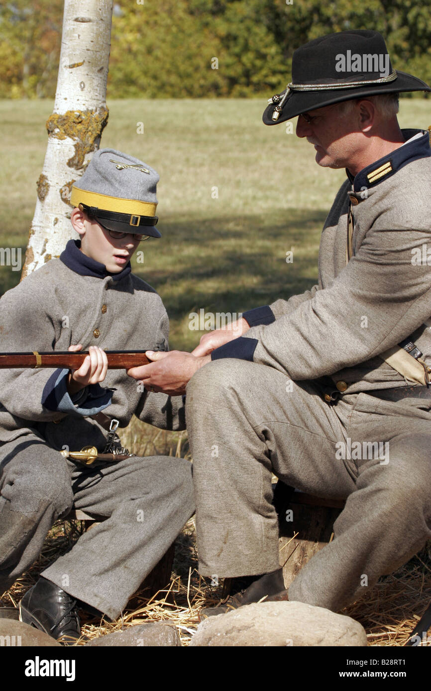 A confederate soldier father sitting at the campfire with his son ...