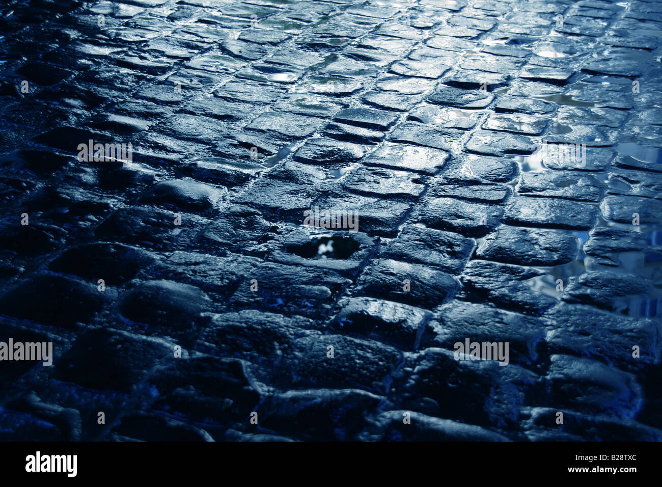 wet pavement cobbles in rain at night Stock Photo - Alamy