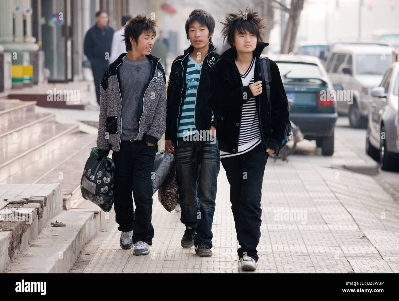 Chinese teenagers walk down a street in Xian China Stock Photo - Alamy