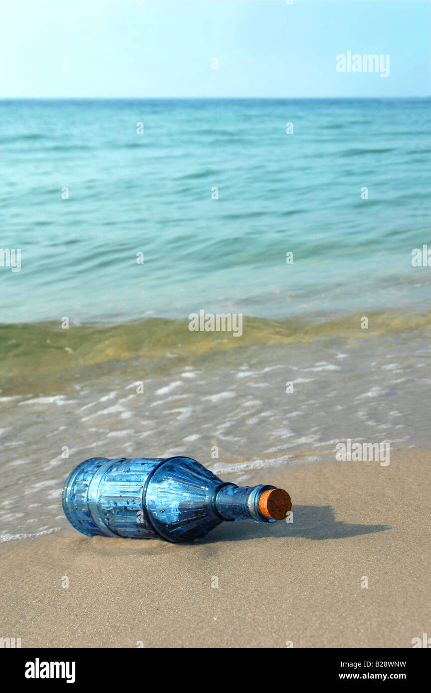 Message in an old bottle on a remote shore Stock Photo - Alamy