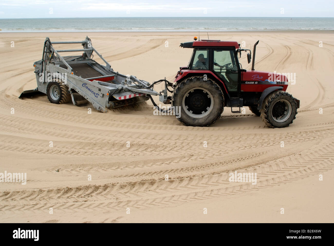 Seaside beach cleaning machine tractor pulled seen here in action in ...