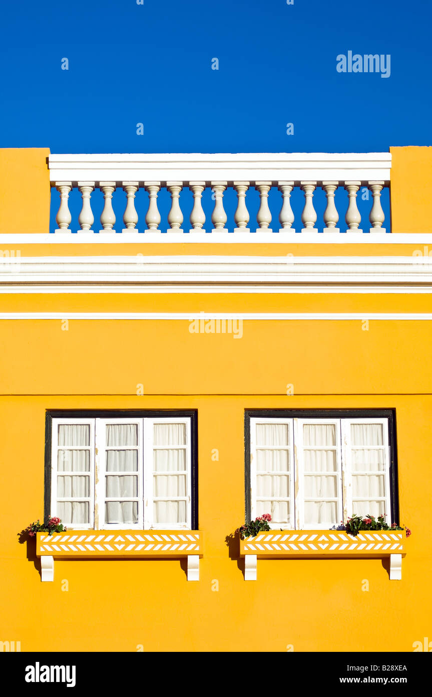 Bright yellow building with square windows Stock Photo - Alamy
