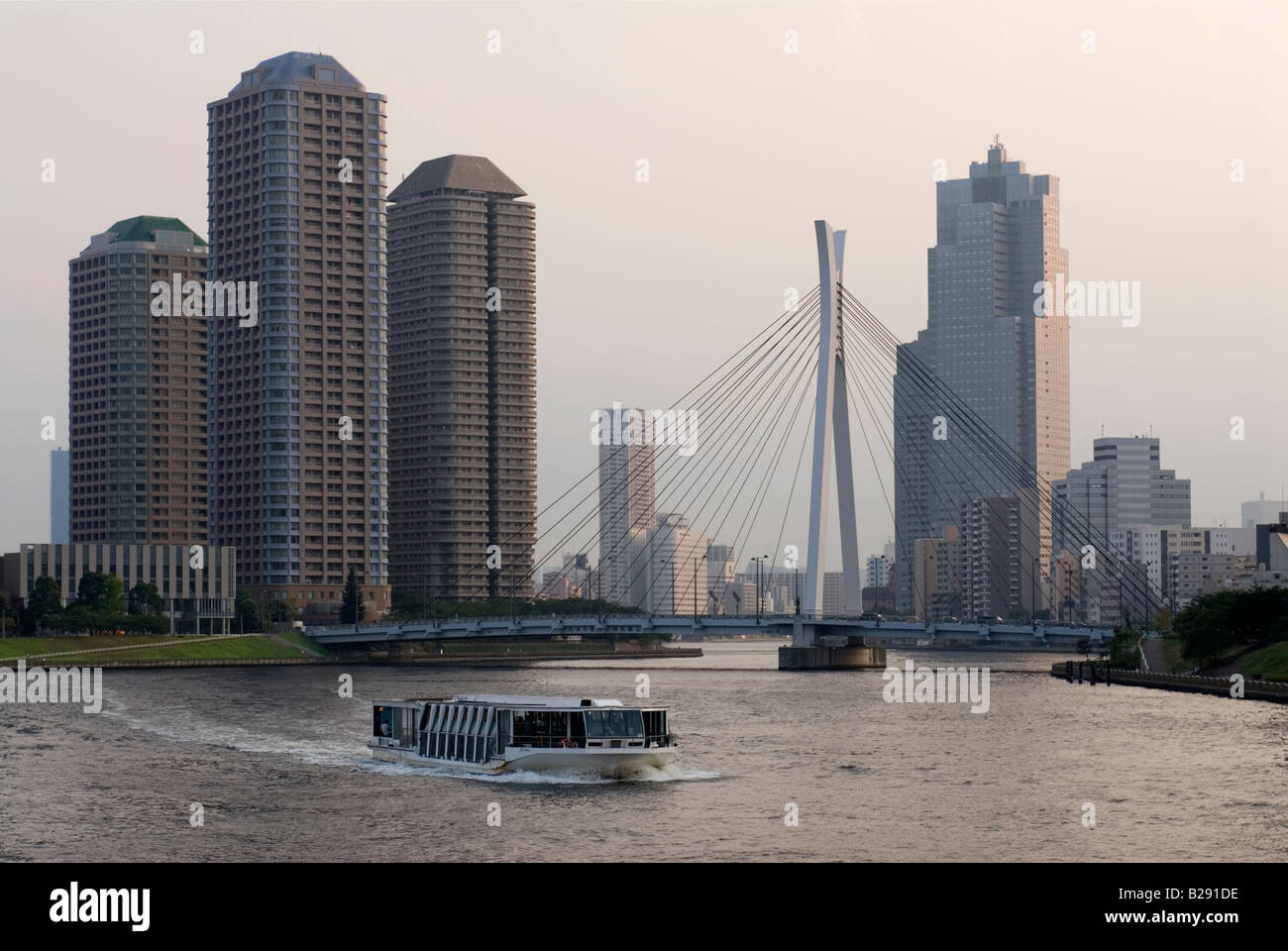 Sightseeing cruise boat making its way along the Sumida River past the ...