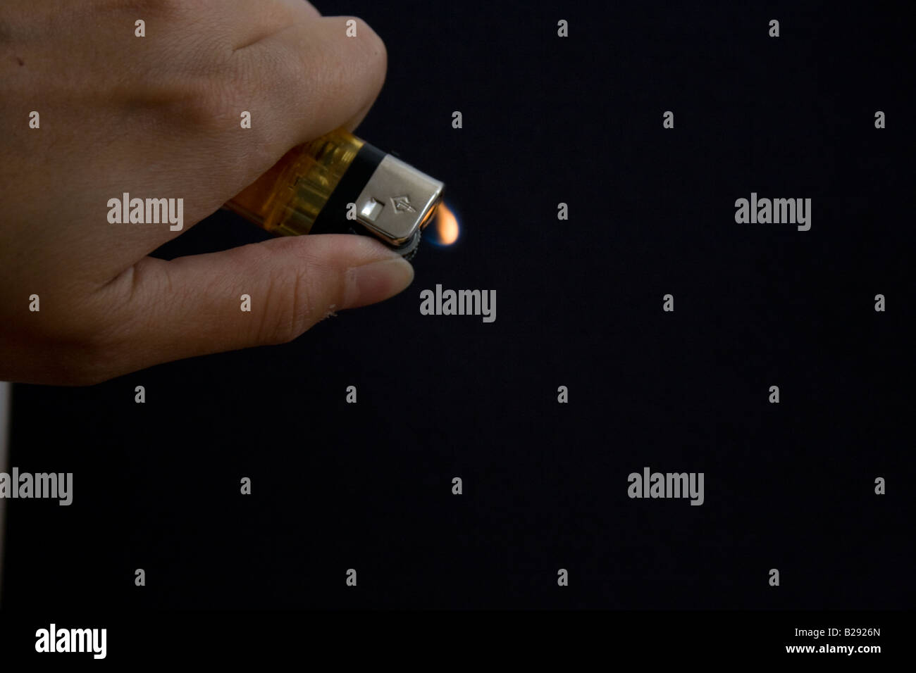 Someone holding a lighter Stock Photo - Alamy