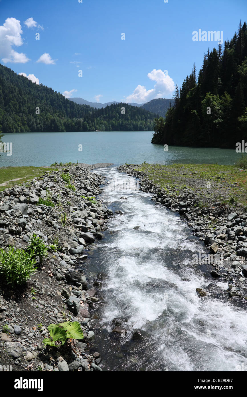 Mountain inflowing river Stock Photo - Alamy