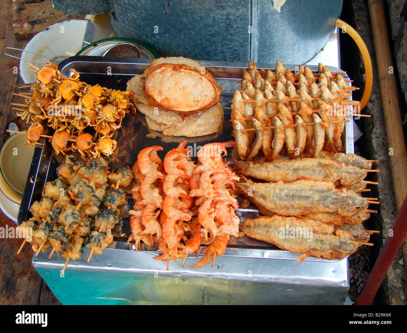 Barbecue with fish spits Stock Photo - Alamy