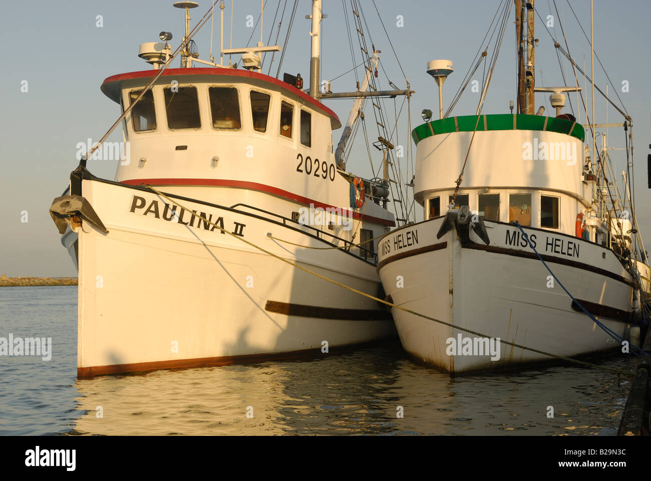 Wooden Fishing Boats tied Together Stock Photo - Alamy