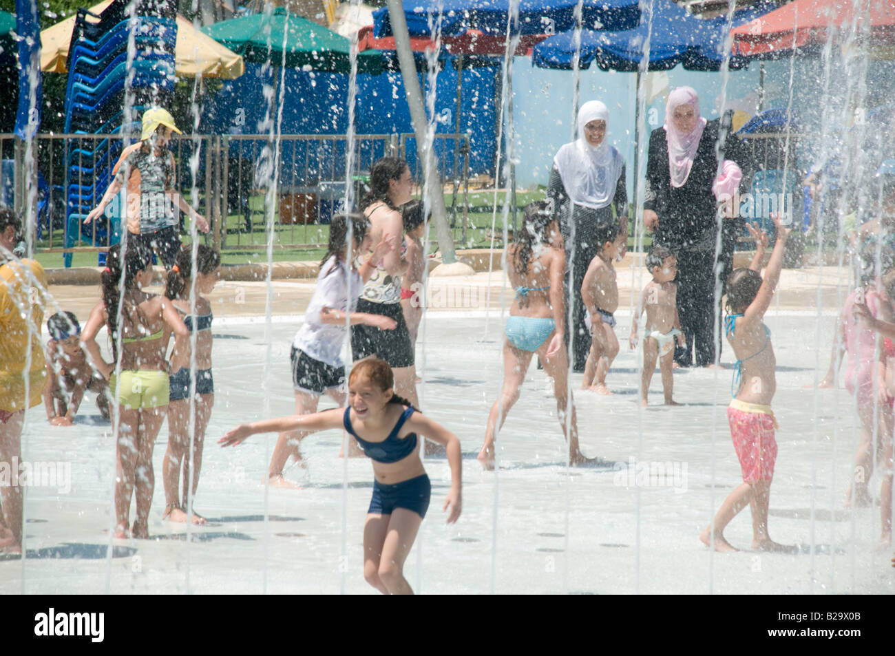 Israel Sfaim water Park summer fun children playing in water jets Stock ...