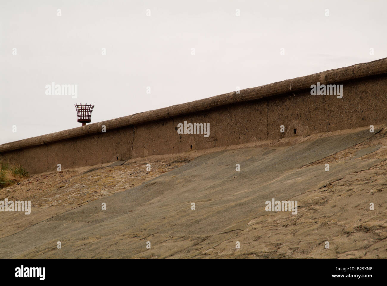Sea wall with beacon above Stock Photo - Alamy