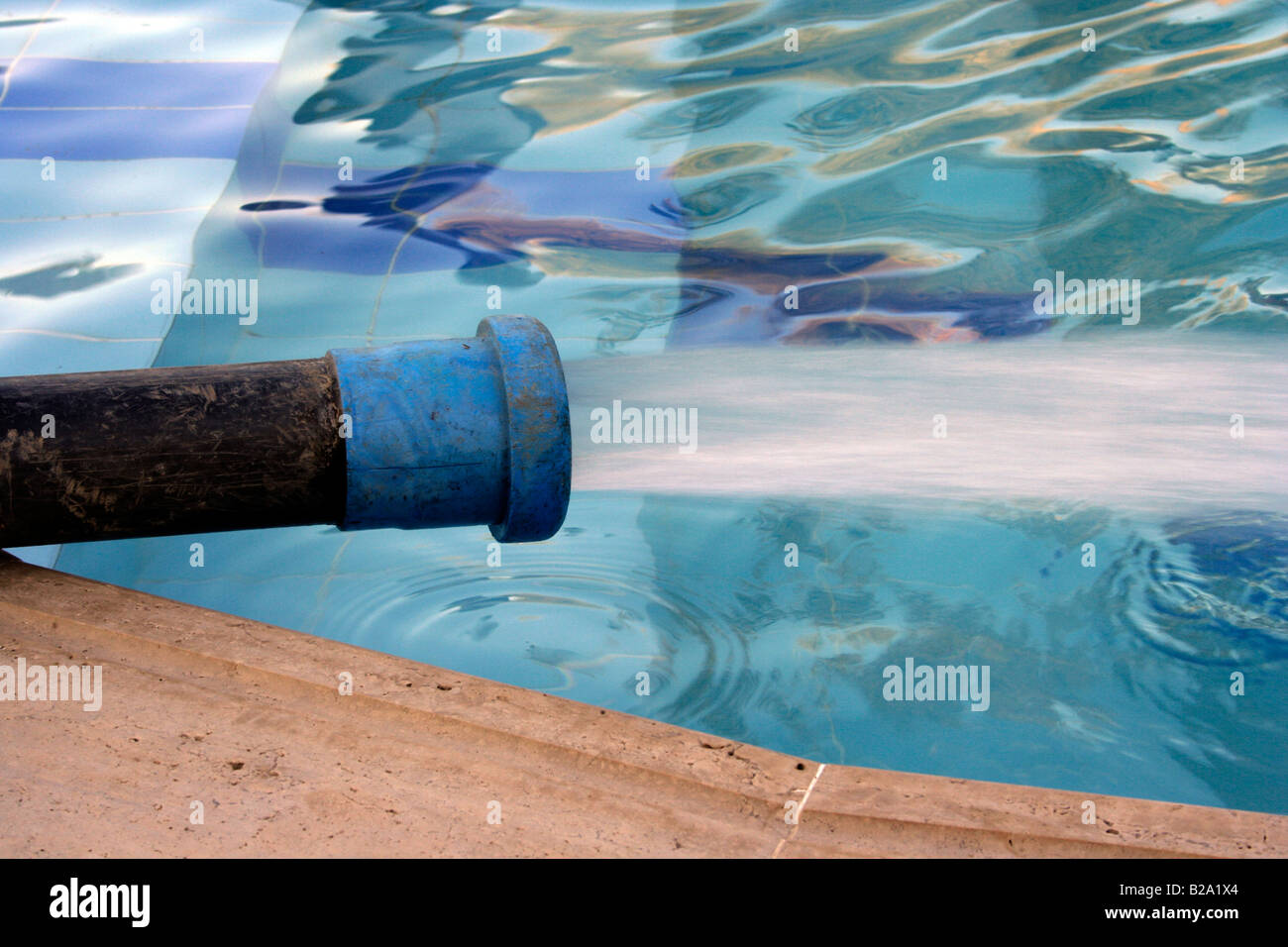 Topping up the Swimming Pool Stock Photo - Alamy