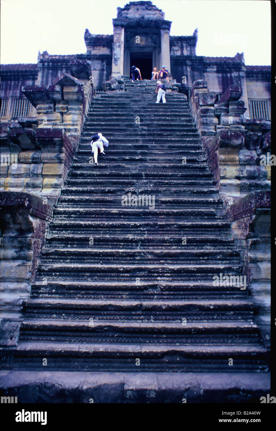 Tourists climbing the stairs at the Angkor Wat Temple, Siem Reap ...
