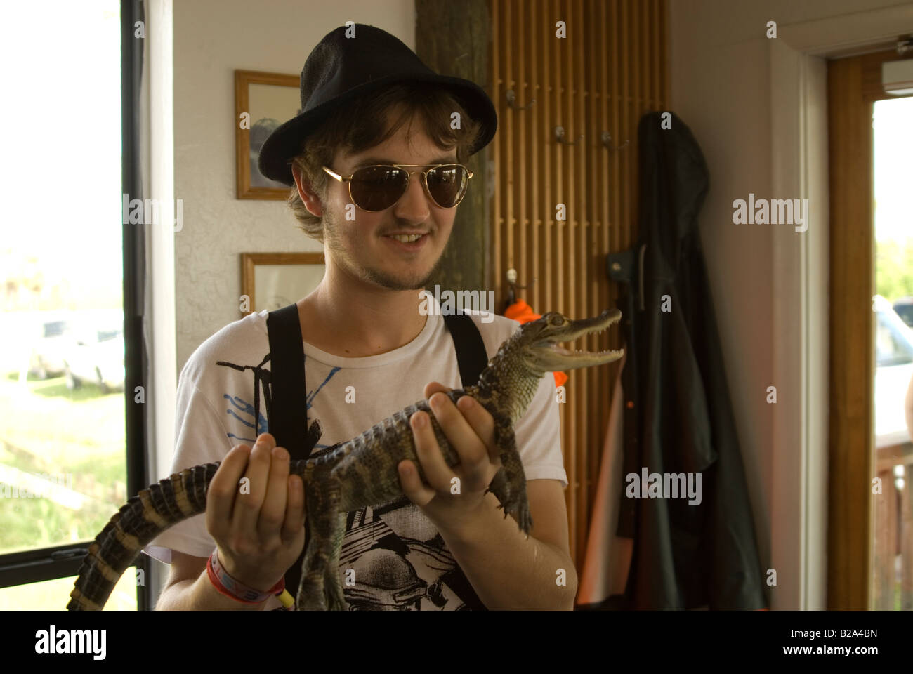 Teenager holding baby alligator hi-res stock photography and images - Alamy