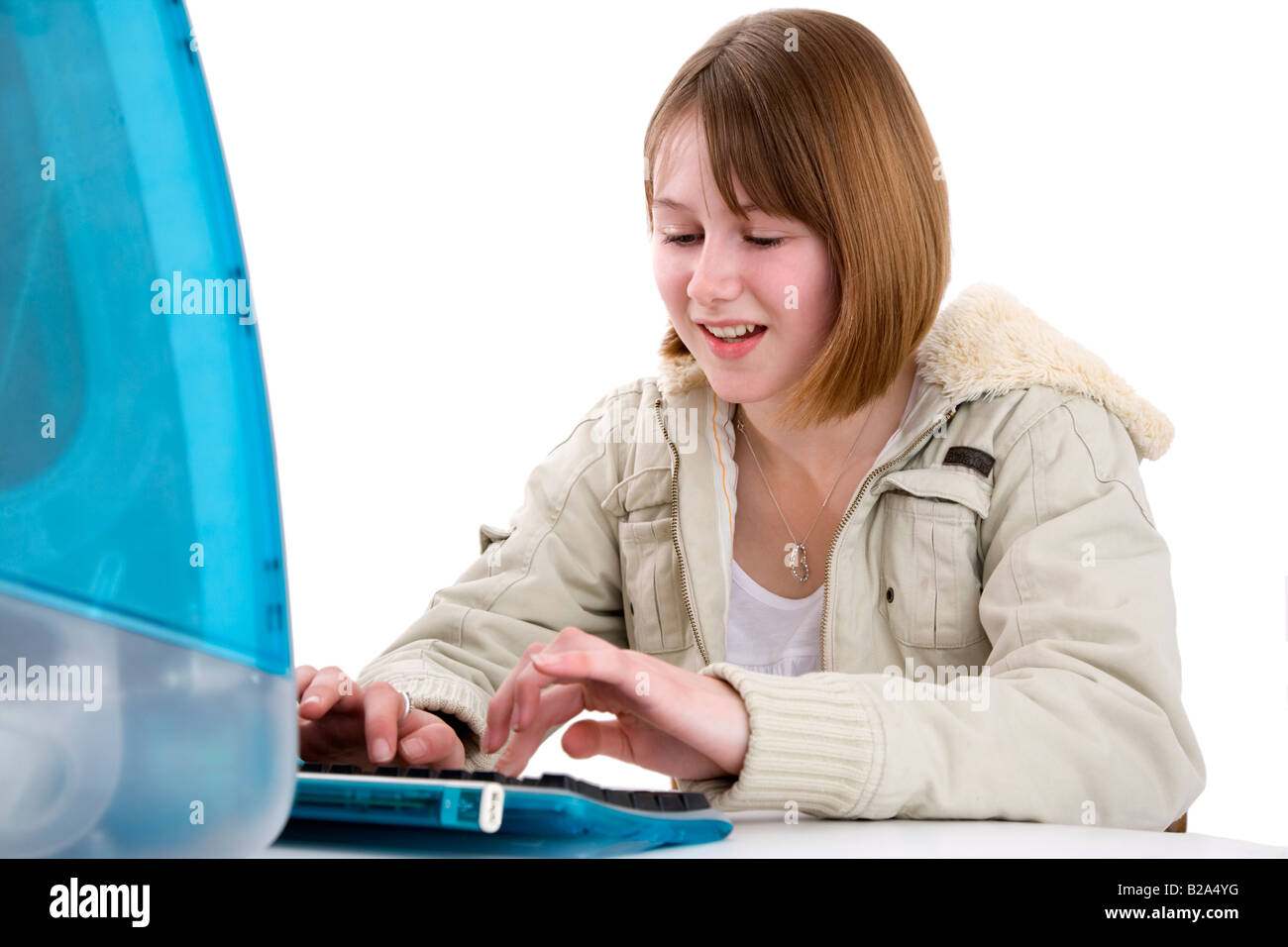 Teenage girl typing on blue iMac computer Stock Photo - Alamy