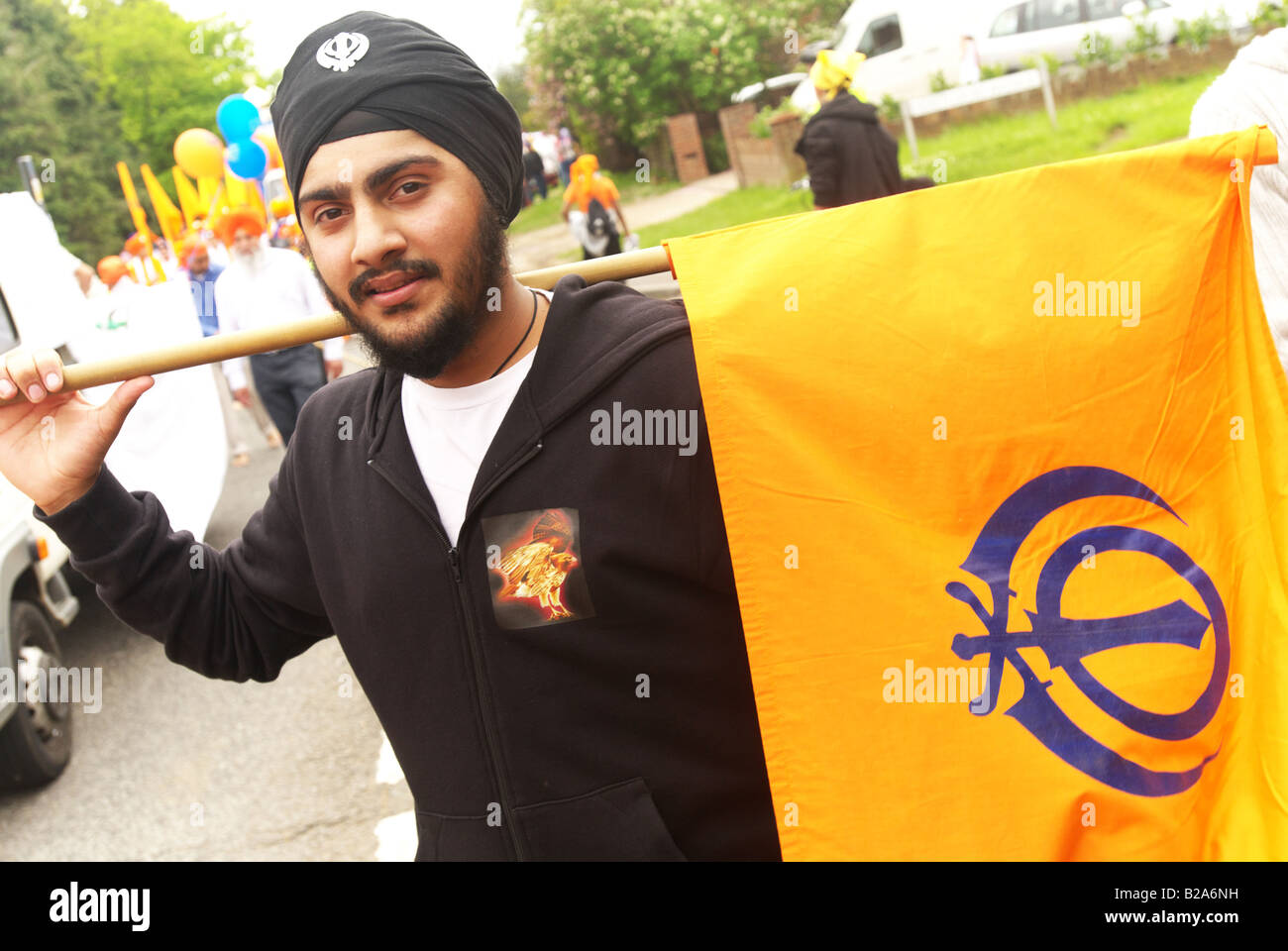 A Sikh holds a flag during the Festival of Vaisahki Stock Photo - Alamy