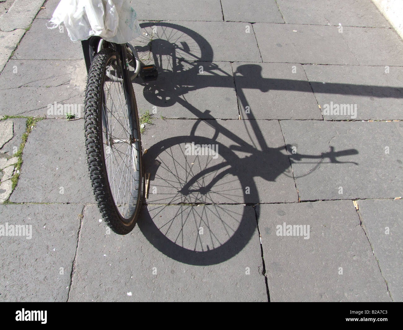 one bike shadow on sidewalk road in sun Stock Photo - Alamy