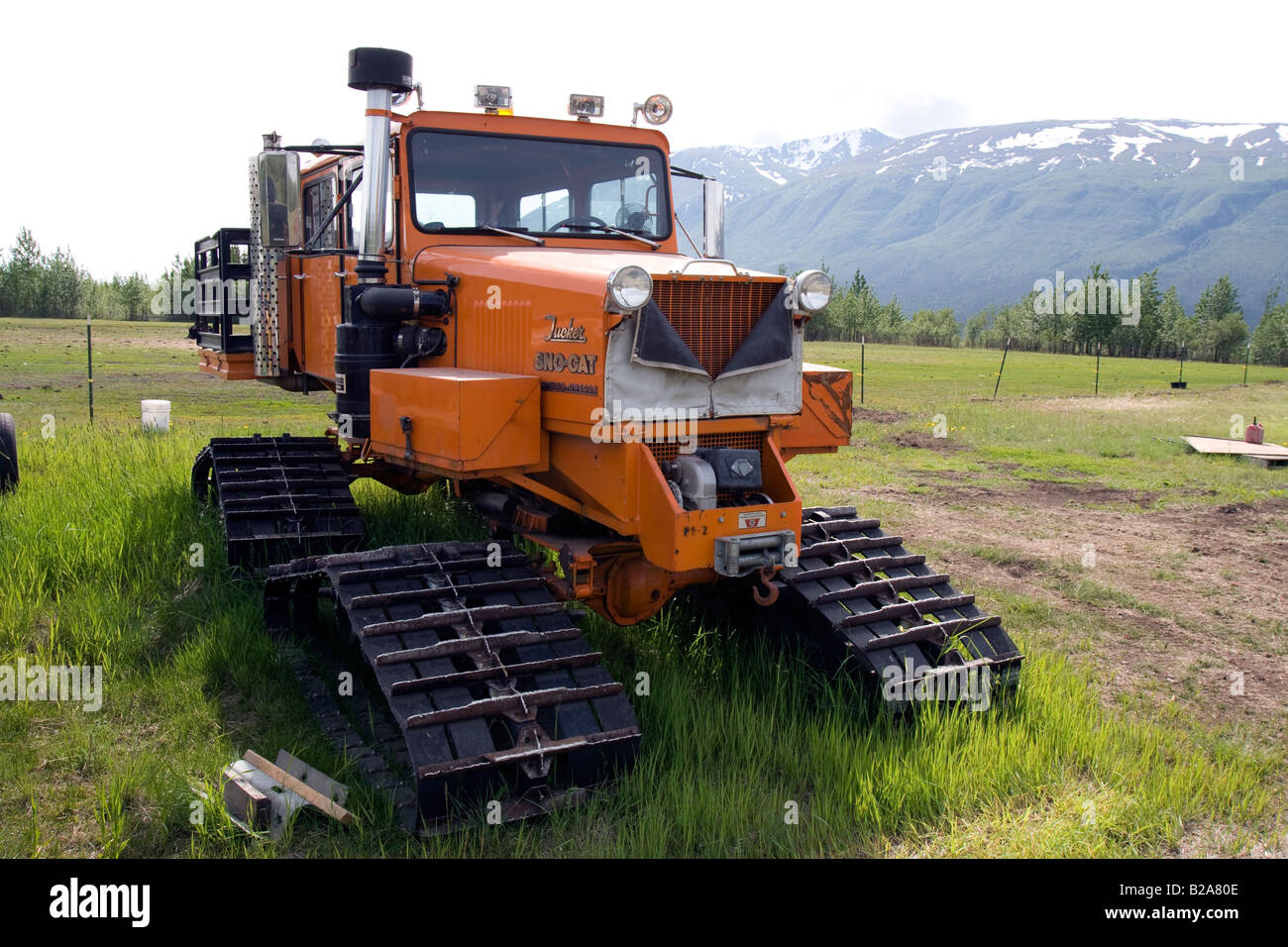 Winter tractor on tracks standing in the grass waiting for winter to ...