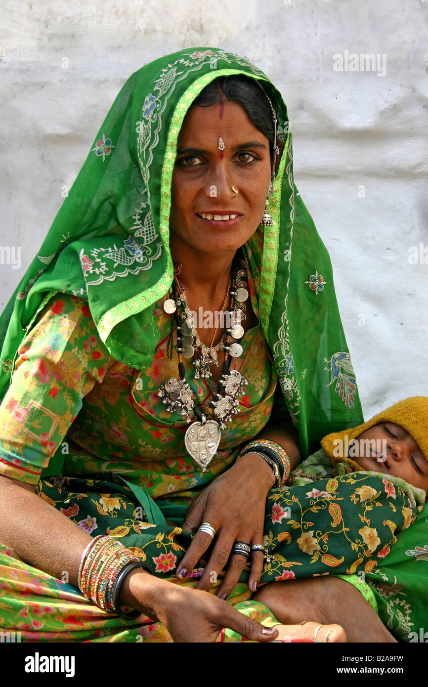 Portrait of a beautiful Rajasthani woman in a decorated green sari ...