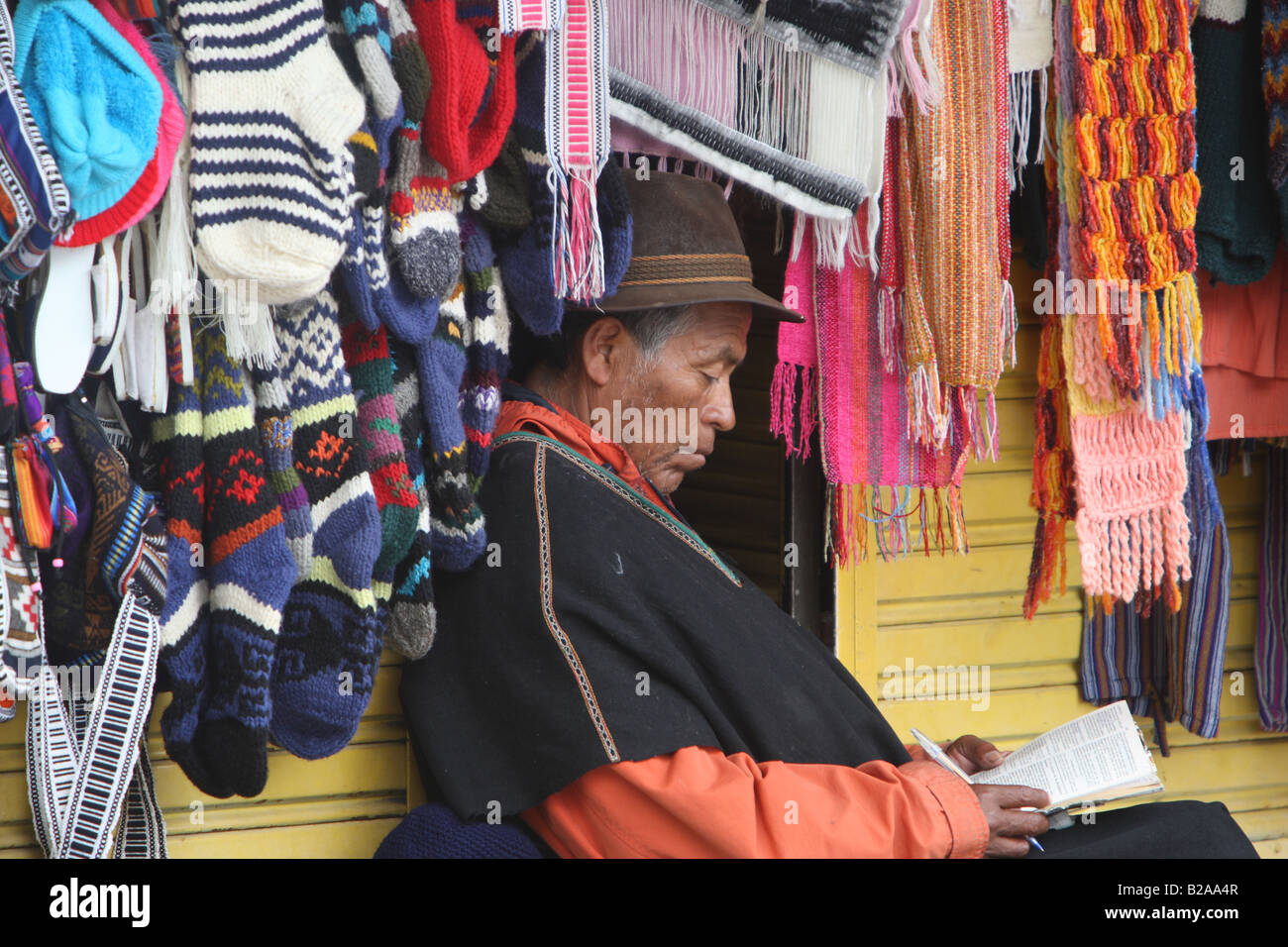 man reading book on stall in s.america Stock Photo - Alamy
