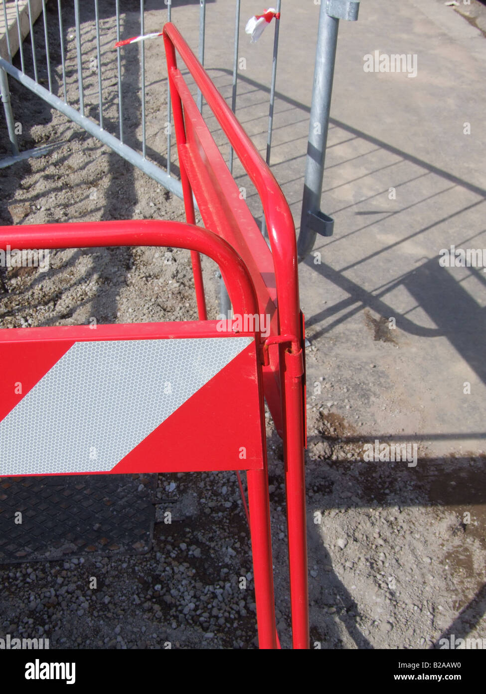 red white road works barrier on street in town Stock Photo - Alamy