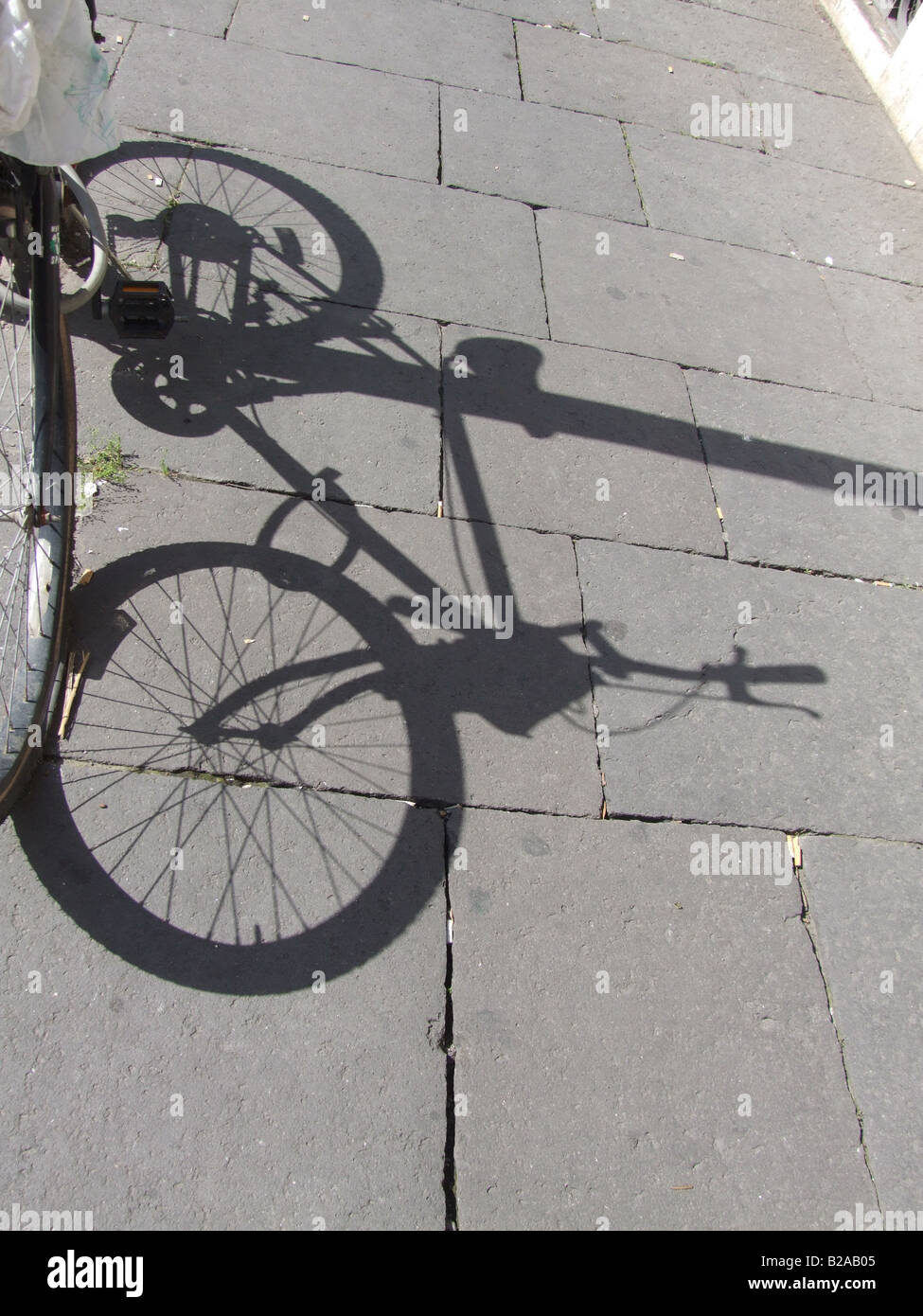 one bike shadow on sidewalk road in sun Stock Photo - Alamy