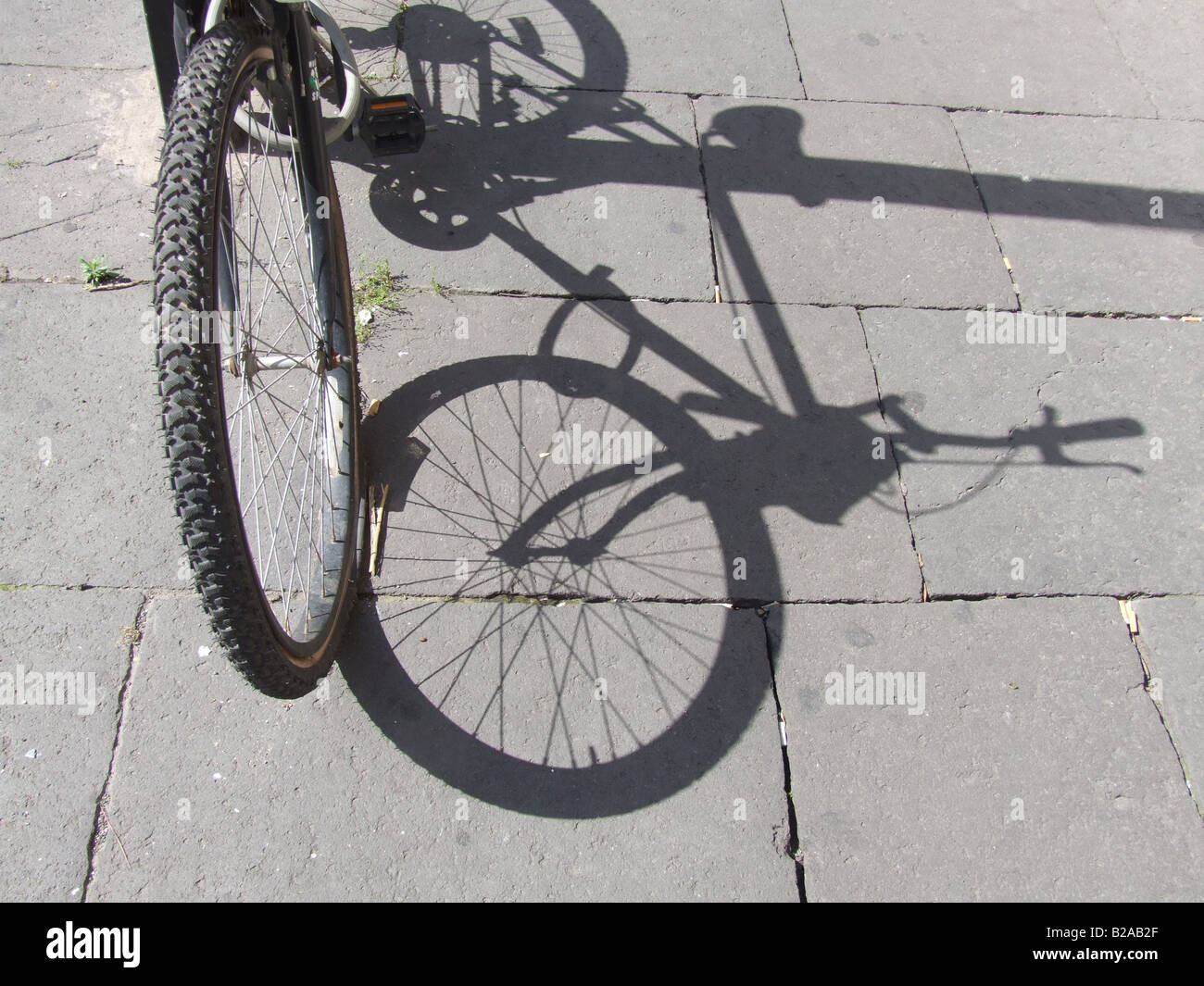 one bike shadow on sidewalk road in sun Stock Photo - Alamy