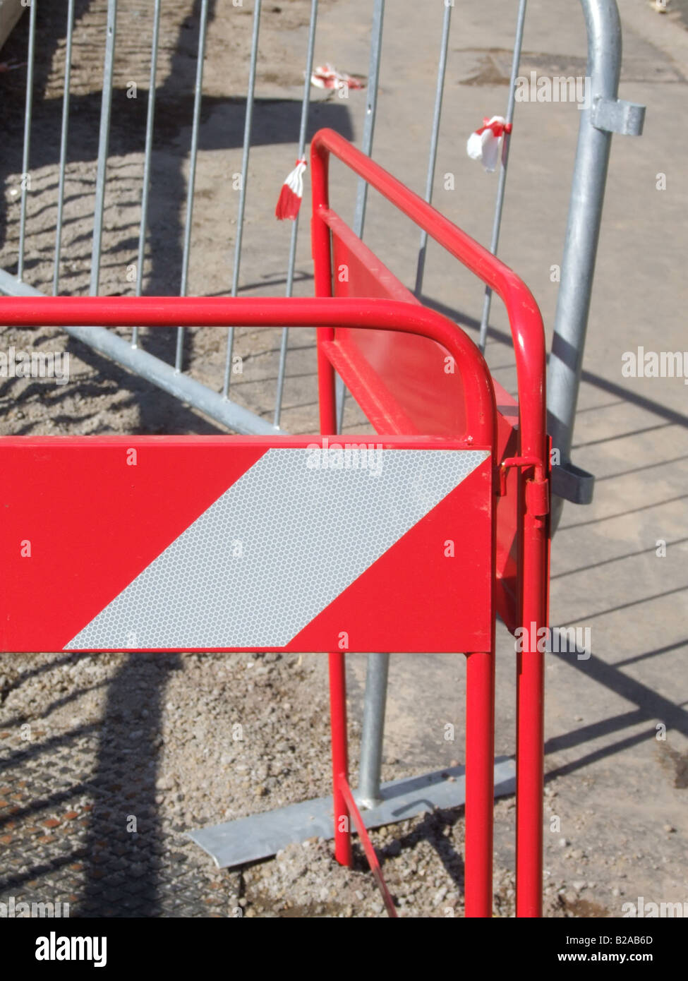 red white road works barrier on street in town Stock Photo - Alamy