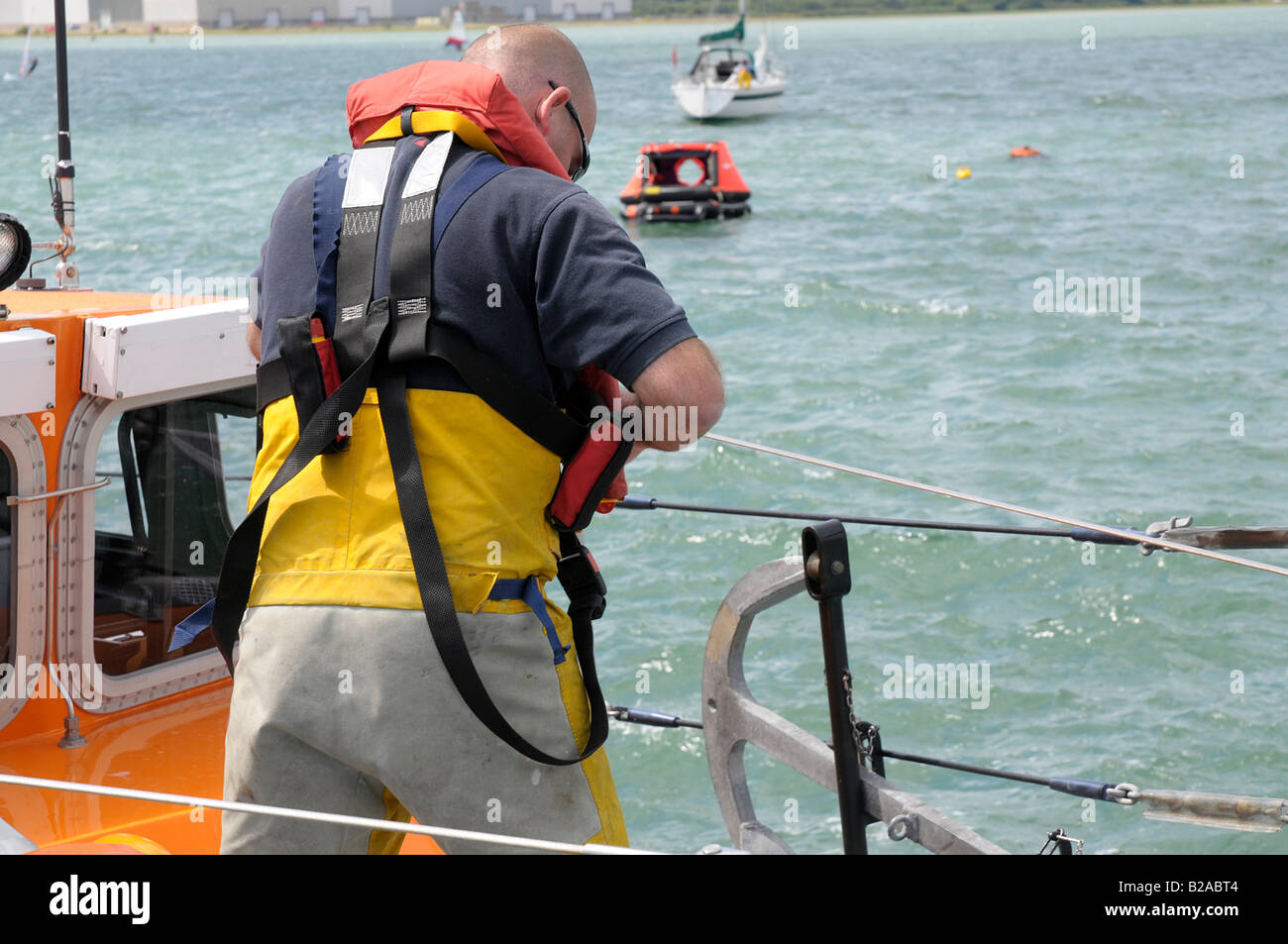 A crew member dons a lifejacket as the lifeboat is about to attend a ...