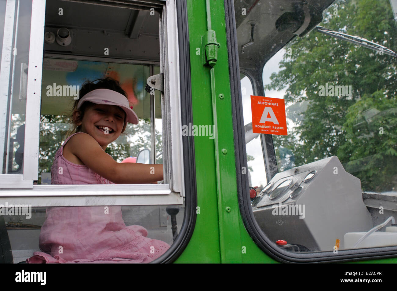 Little girl driving bus London UK Stock Photo - Alamy