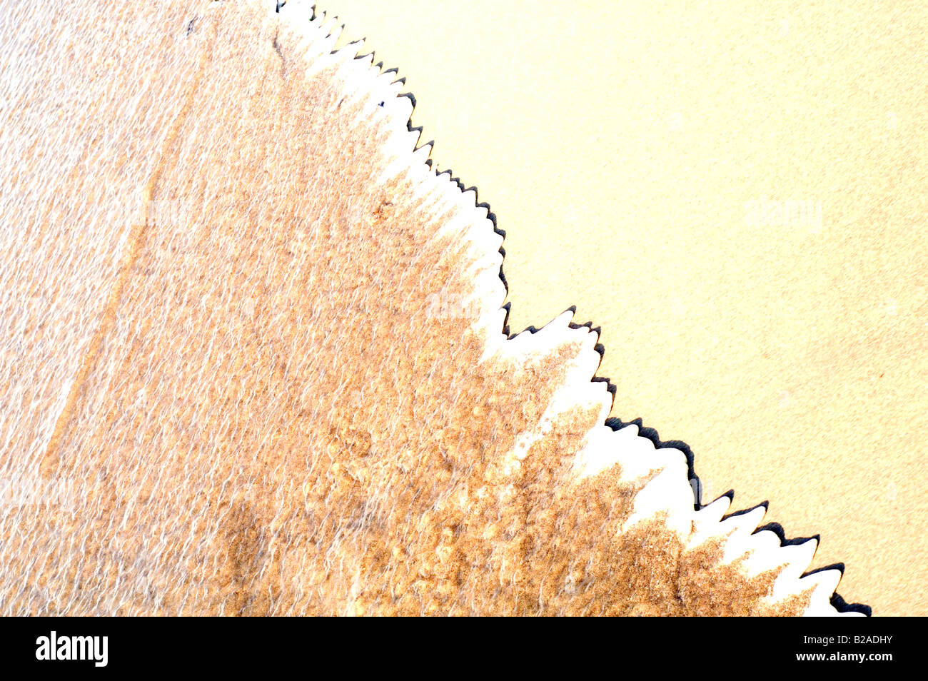 Water rolling over sand on the ocean beach Stock Photo - Alamy