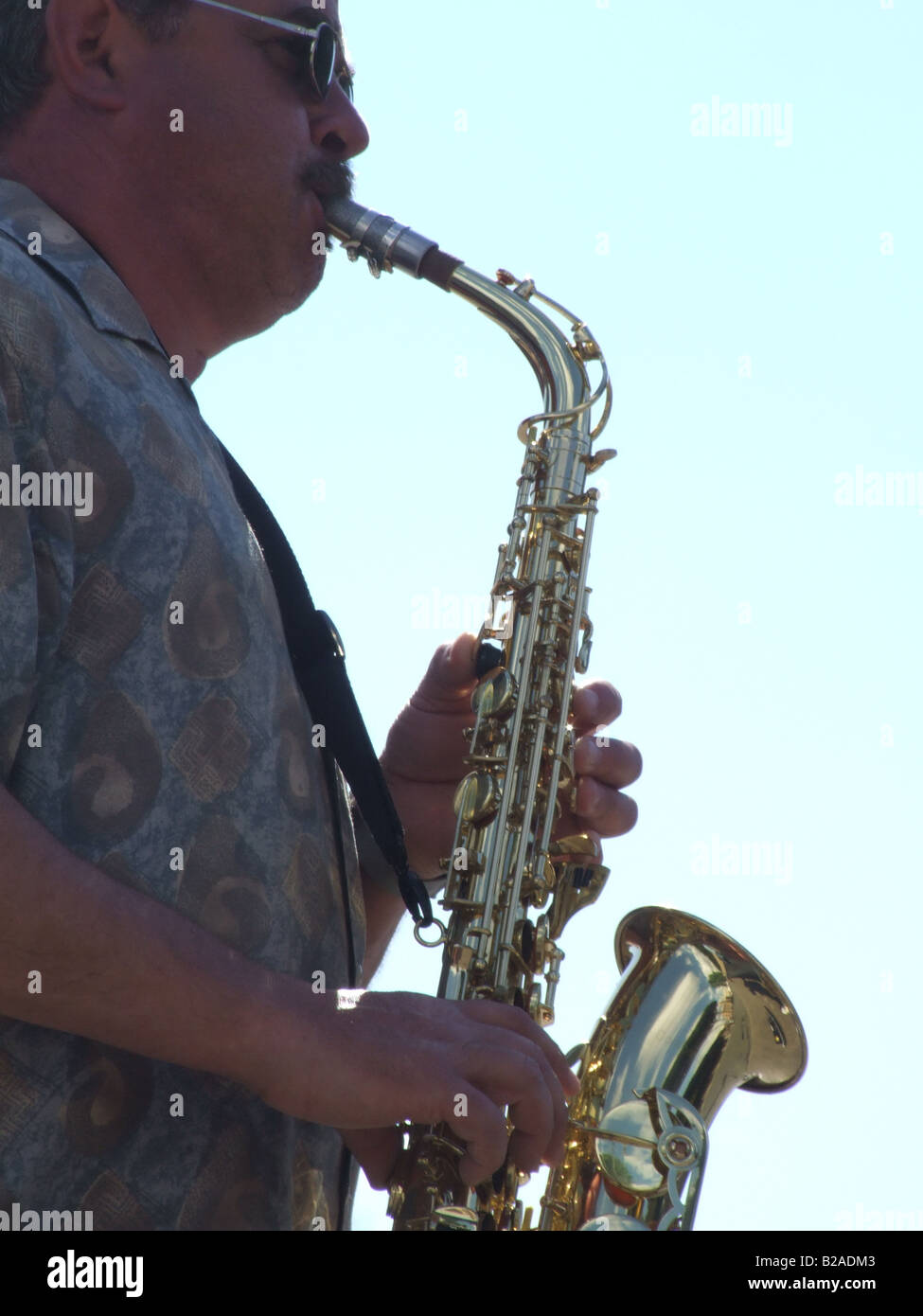man busker playing saxophone in street Stock Photo - Alamy