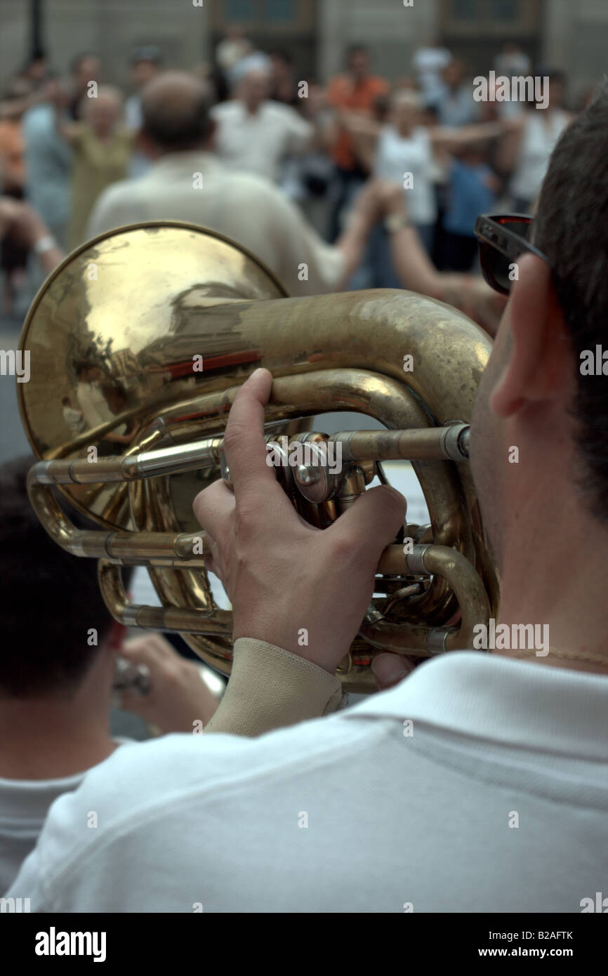 Man playing a 'fiscorn' and people dancing the 'sardana' in the street ...