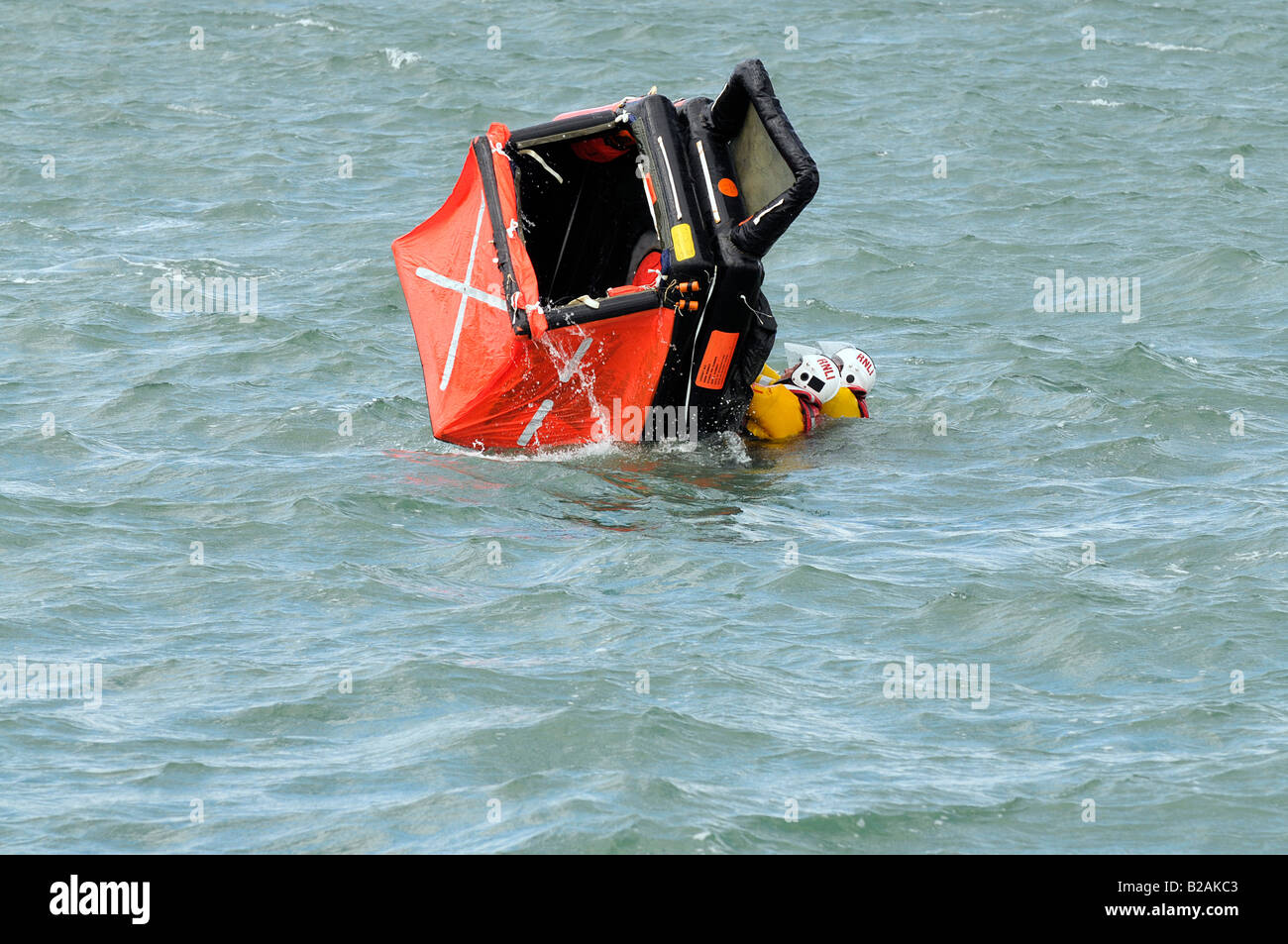 RNLI Crew members righting an inflatable liferaft during a rescue ...